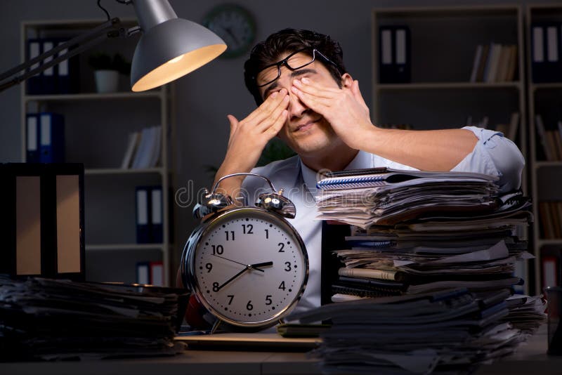 The Young Businessman Working Overtime Late in Office Stock Photo ... The Young Businessman Working Overtime Late in Office Stock Photo ...