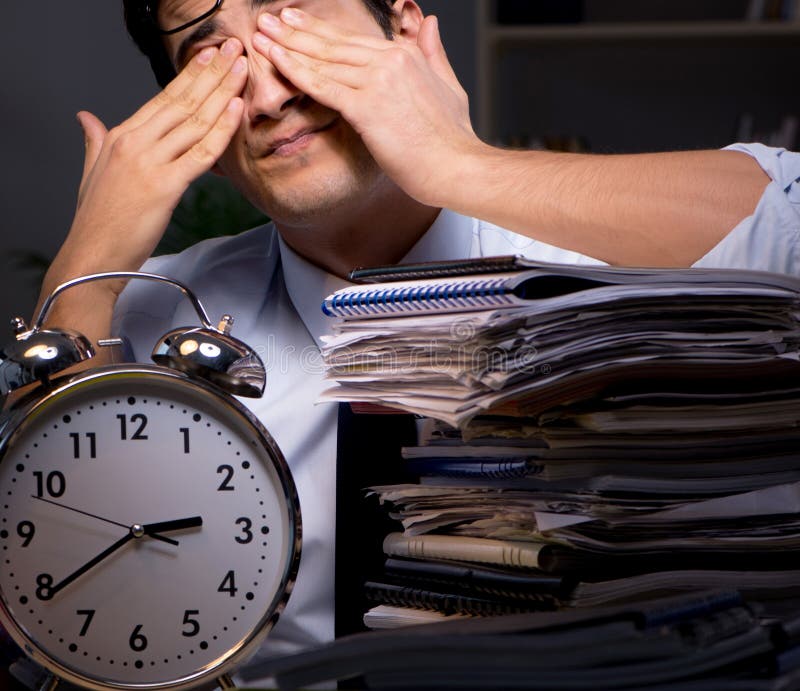 Young Businessman Working Overtime Late in Office Stock Photo - Image ... Young Businessman Working Overtime Late in Office Stock Photo - Image ...