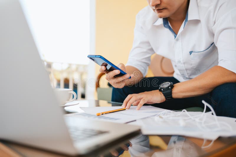Young Businessman Working and Using Smart Phone and Notebook Computer ...