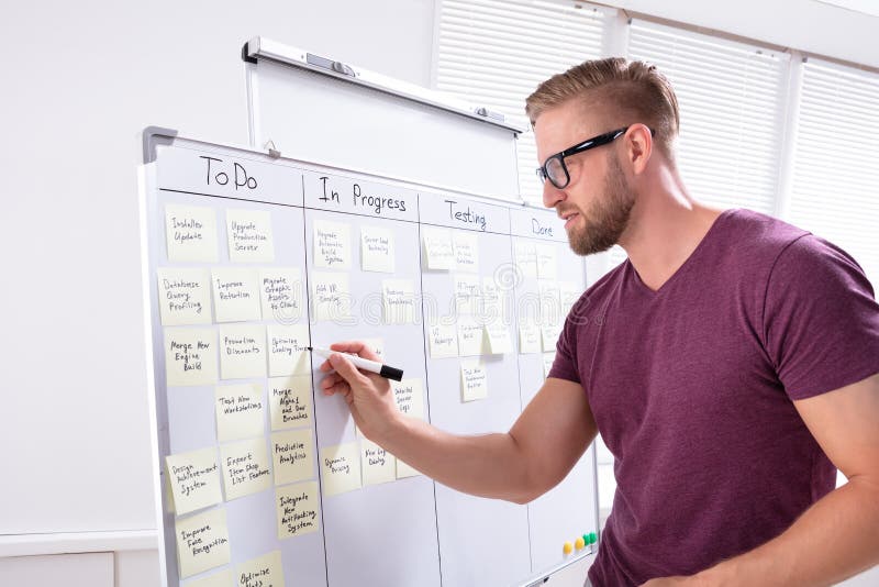 Young Businessman Writing on Sticky Notes Stock Image - Image of casual ...