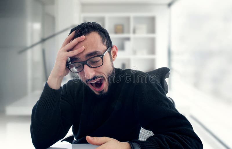 Young Businessman Yawning at Work in Office . Stock Photo - Image of ...