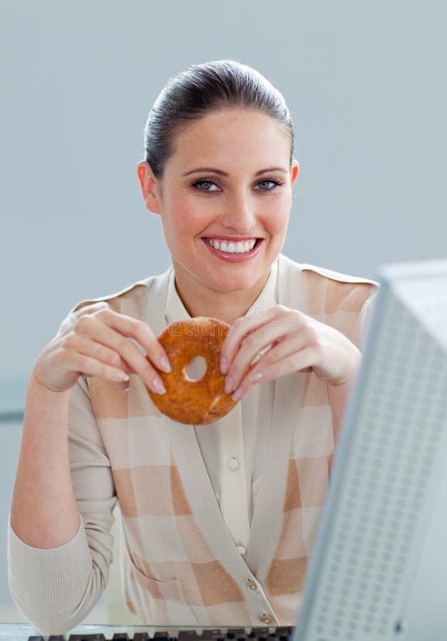 Young Businesswoman Eating a Donut Stock Image - Image of businesswoman ...