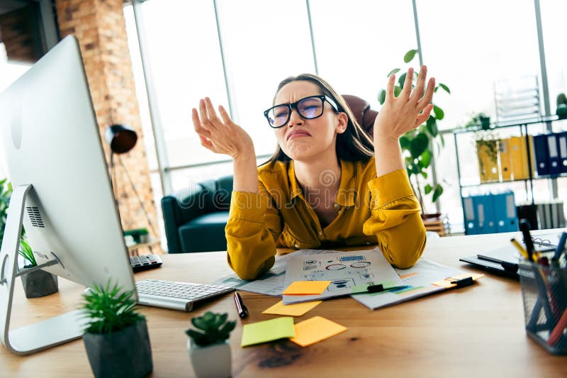 Young Businesswoman Feeling Frustrated at Her Modern Workspace with ...