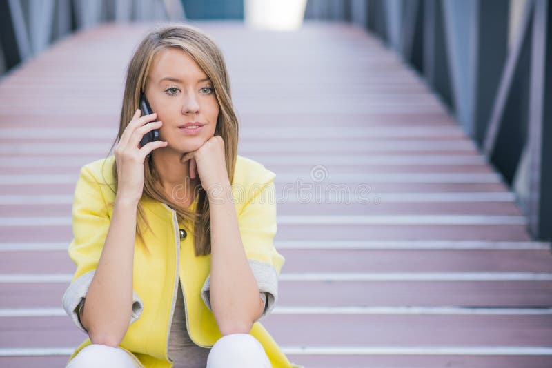 Young Businesswoman Having a Conversation Using a Smartphone on a Phone ...