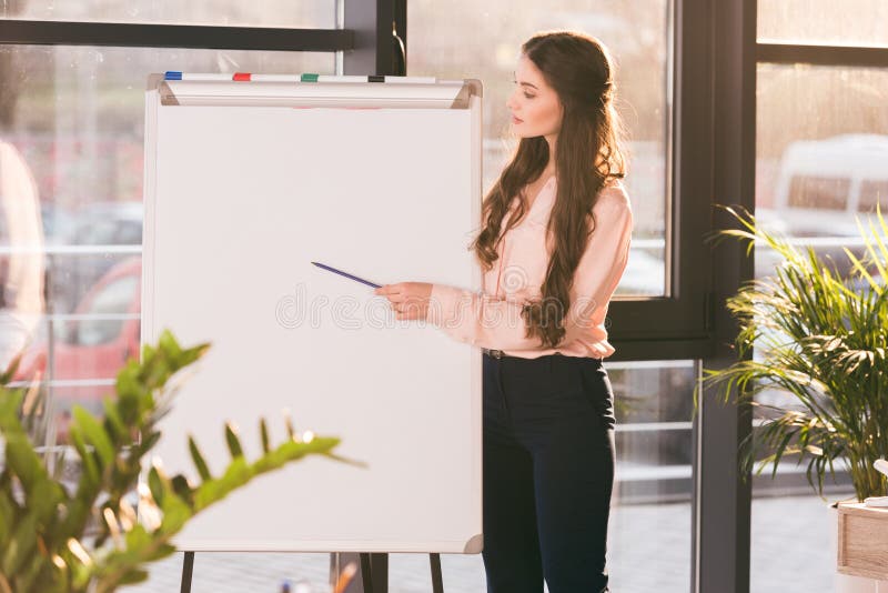 Young Businesswoman Making Presentation and Pointing at Blank ...