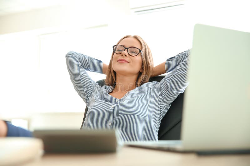 Young Businesswoman Relaxing at Workplace in Office Stock Image - Image ...