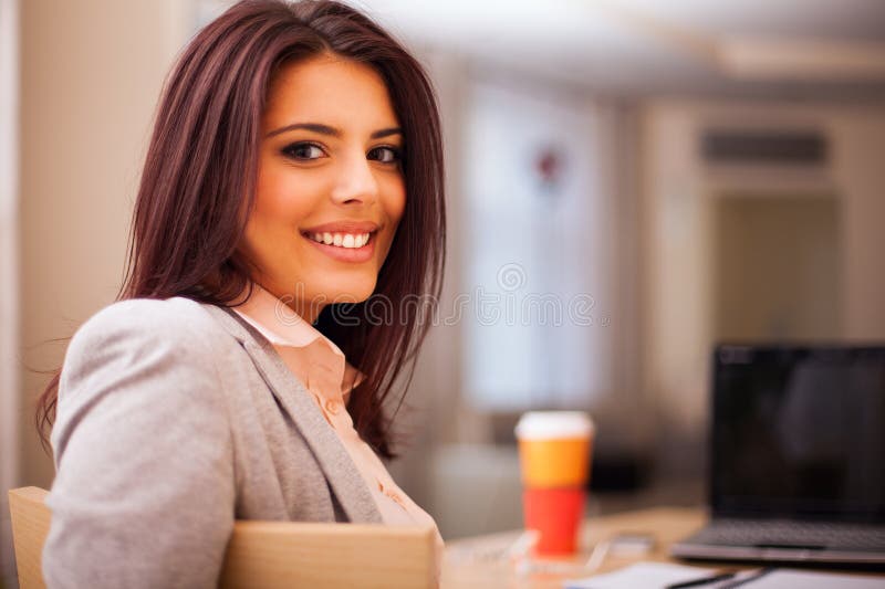Young Businesswoman Sitting at Desk and Working Stock Image - Image of ...