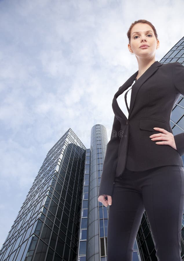 Giant Young Businesswoman Standing Behind Office Building Stock Photo ...