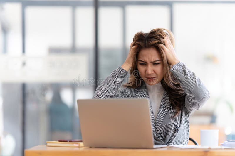 Young Businesswoman Working on Laptop Stressed Has a Headache and ...
