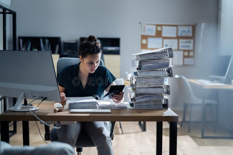 Young Businesswoman Working at Office with Stack of Folders Stock Photo ...