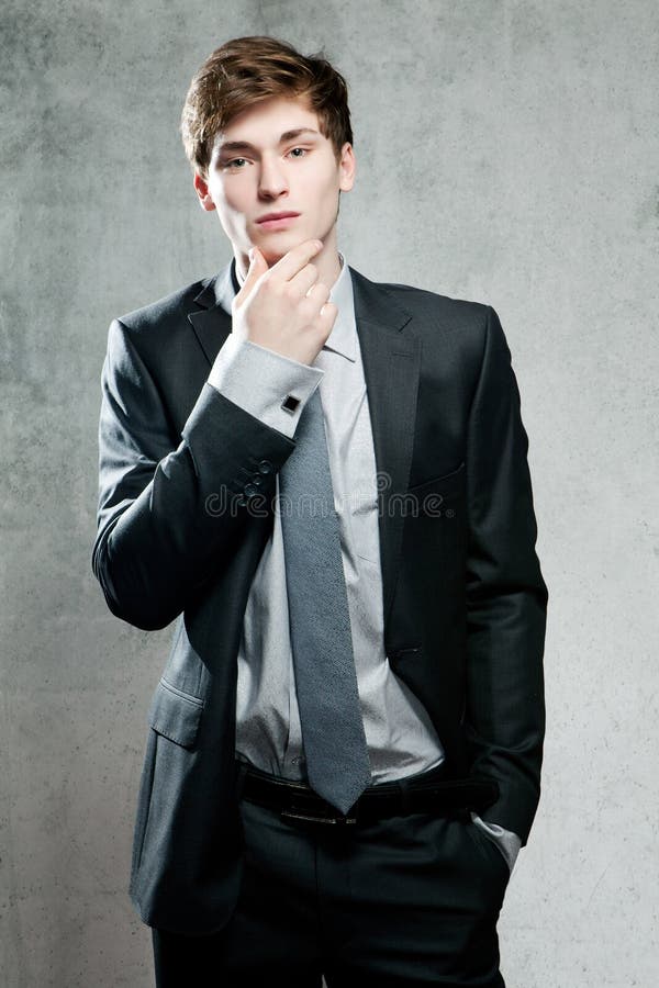 Young man in suit thinking stock image. Image of wear - 39424389