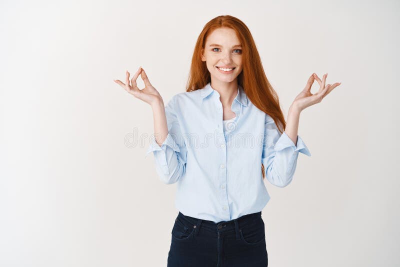 Young Calm Business Woman with Red Hair Meditating, Holding Hands in ... Young Calm Business Woman with Red Hair Meditating, Holding Hands in ...