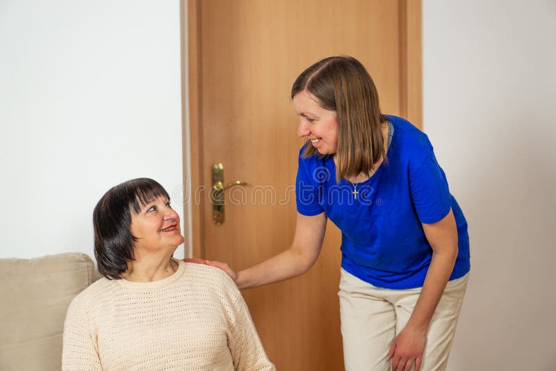 Young Caregiver Helping Senior Woman At Home Caring Nurse Assisting
