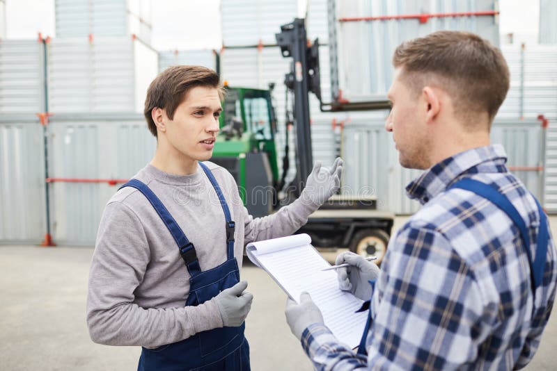 Young Cargo Employee Asking Foreman about Loading Stock Image - Image ...
