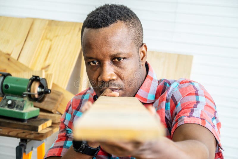 Young Carpenter African American Man Looking And Choosing Wood And