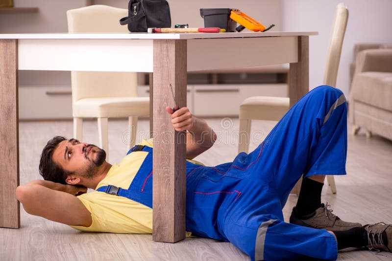 Young Male Carpenter Repairing Table at Home Stock Image - Image of ...