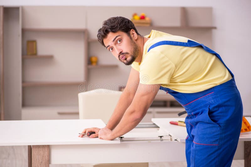 Young Male Carpenter Repairing Table at Home Stock Image - Image of ...