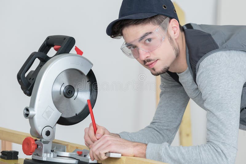 Young Carpenter Using Circular Saw for Wood Inside Warehouse Stock ...