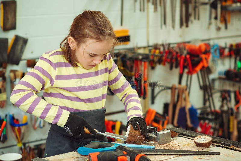 Boy in the Workshop Makes Crafts with Coconut. Young Carpenter Working ...