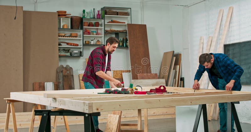 Young Carpenters Build a Solid Wood Wall in a Carpentry Workshop Stock ...