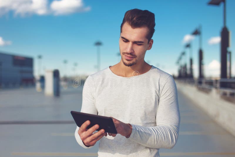 Young Man Using Digital Tablet Outdoor, Large Space Stock Photo - Image ...