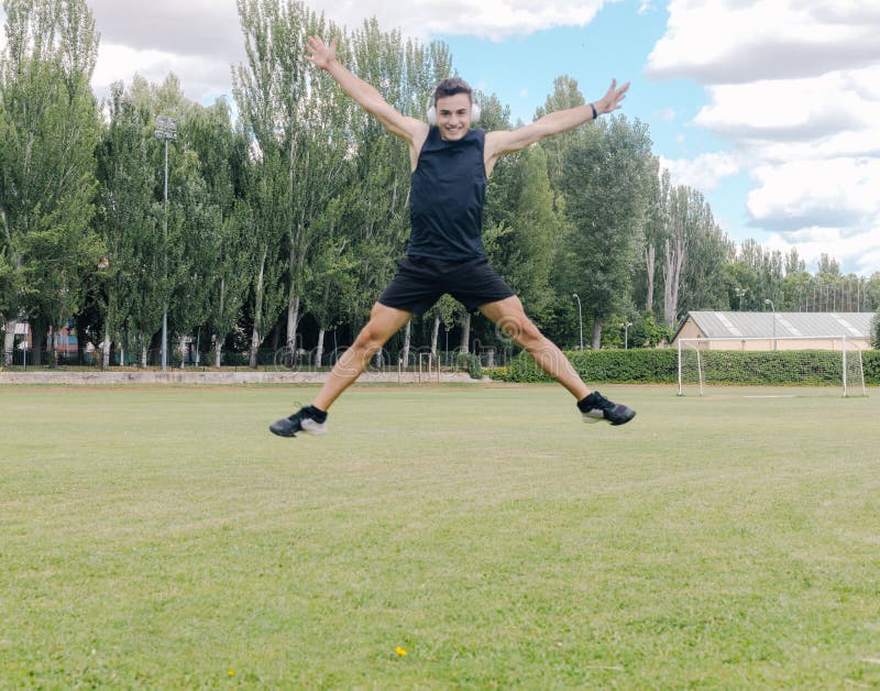 Young Caucasian Athlete Jumping with Open Arms and Looking at the ...