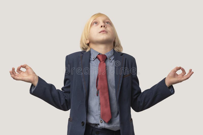 Young Caucasian Boy with Blond Hair Meditating and Looking Up with Calm ...