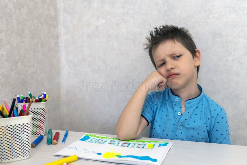 A Young Caucasian Boy Was Thinking during a Drawing Lesson Stock Image ...