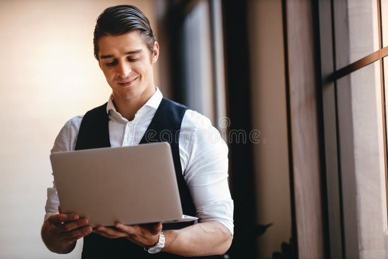 A Young Caucasian Businessman Working on Computer Laptop in the Modern ...