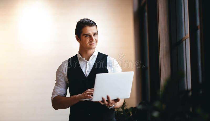 A Young Caucasian Businessman Working on Computer Laptop in the Modern ...