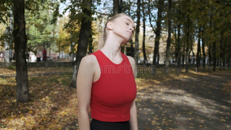 Young Caucasian Busty Woman Stretching Shoulders Arms Outdoors