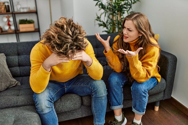 Young Caucasian Couple Arguing Sitting on Sofa at Home Stock Photo ...