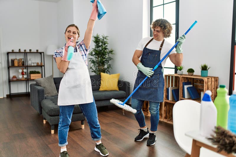 Young Caucasian Couple Cleaning House Stock Image - Image of chores ...