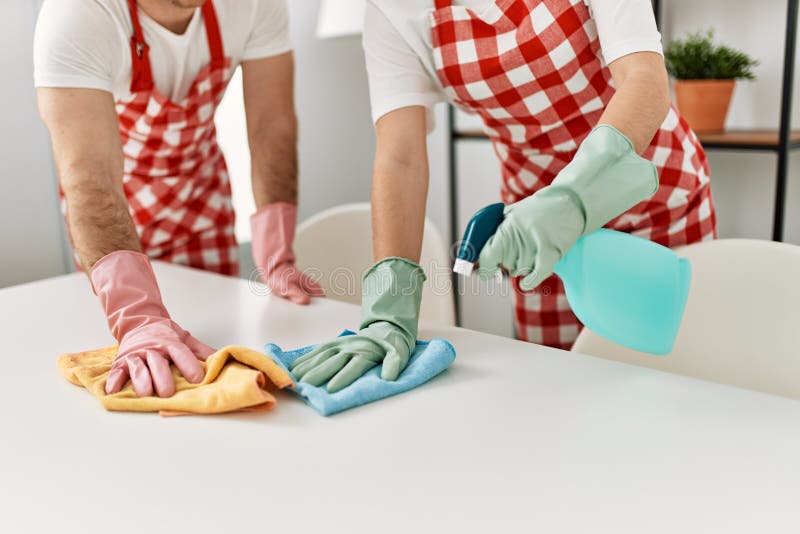 Young Caucasian Couple Cleaning Table Using Rag and Diffuser at Home ...