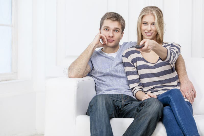Young Caucasian Couple Sitting on Couch Stock Photo - Image of 2025 ...