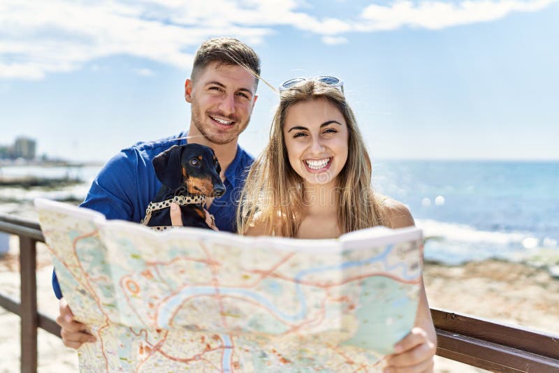 Young Caucasian Couple Standing with Dog Looking Map at the Beach Stock ...