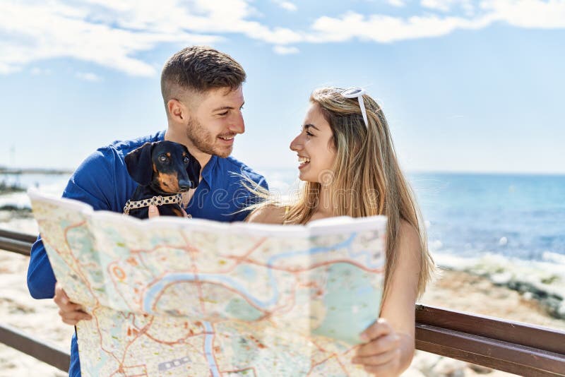 Young Caucasian Couple Standing with Dog Looking Map at the Beach Stock ...