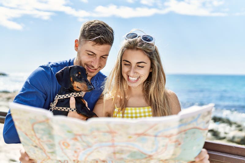 Young Caucasian Couple Standing with Dog Looking Map at the Beach Stock ...