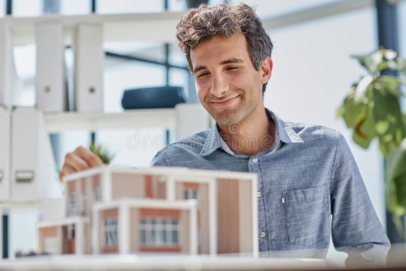 Young Caucasian Engineer Man Making Building Model with the Use of ...