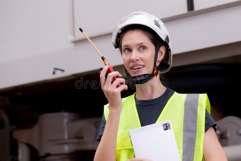 Young Caucasian Engineer Woman Using Radio for Command with Worker ...