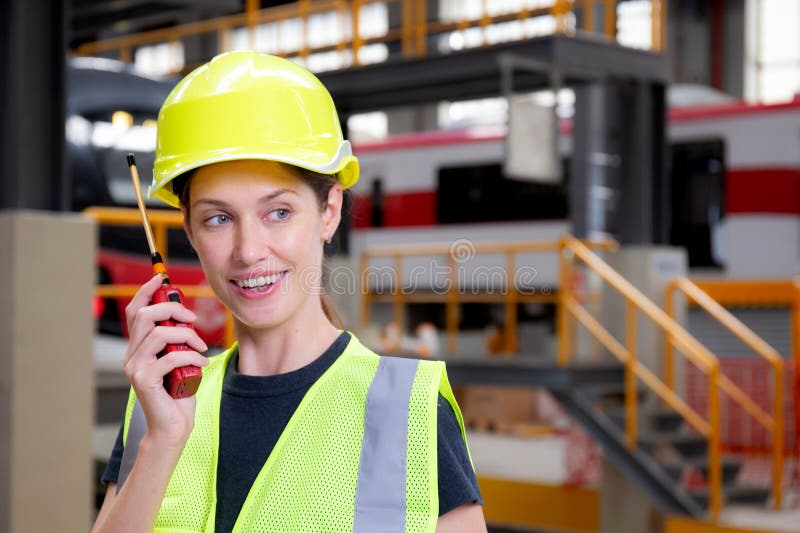 Young Caucasian Engineer Woman Using Radio for Command with Worker ...