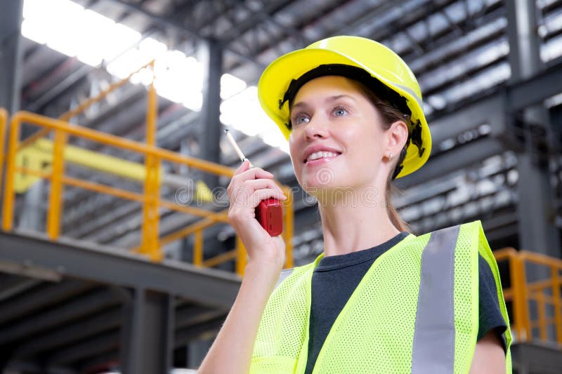 Young Caucasian Engineer Woman Using Radio for Command with Worker ...