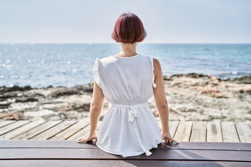 Young Caucasian Girl on Back View Sitting on the Bench at the Beach ...