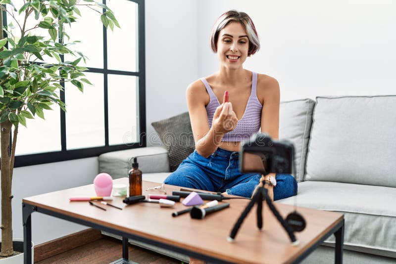 Young Caucasian Girl Making Makeup Tutorial Sitting on the Sofa at Home ...