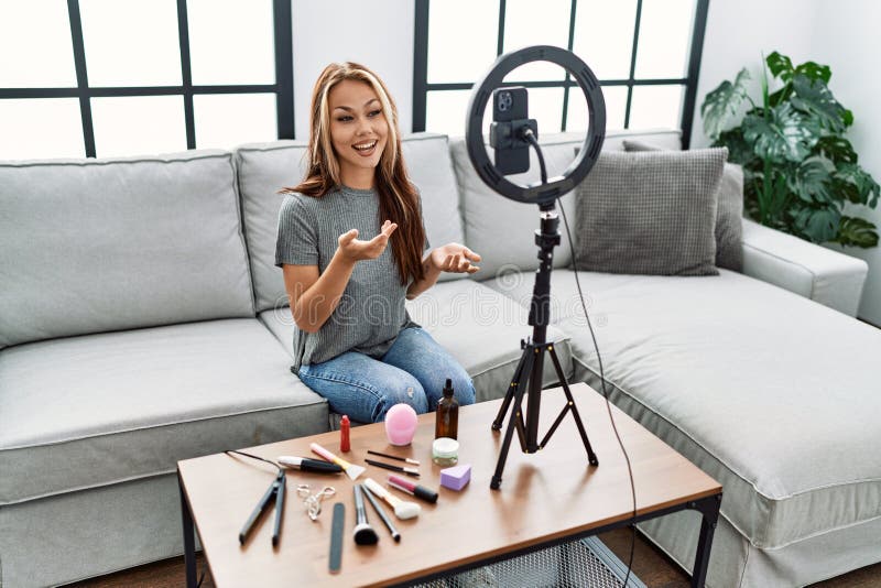 Young Caucasian Girl Making Makeup Tutorial Sitting on the Sofa at Home ...