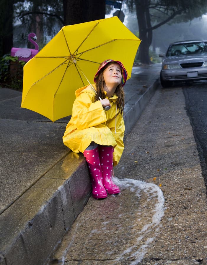 Young Caucasian Girl Playing in the Rain Stock Image - Image of yellow ...