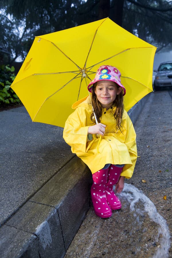 Young Caucasian Girl Playing in the Rain Stock Image - Image of yellow ...