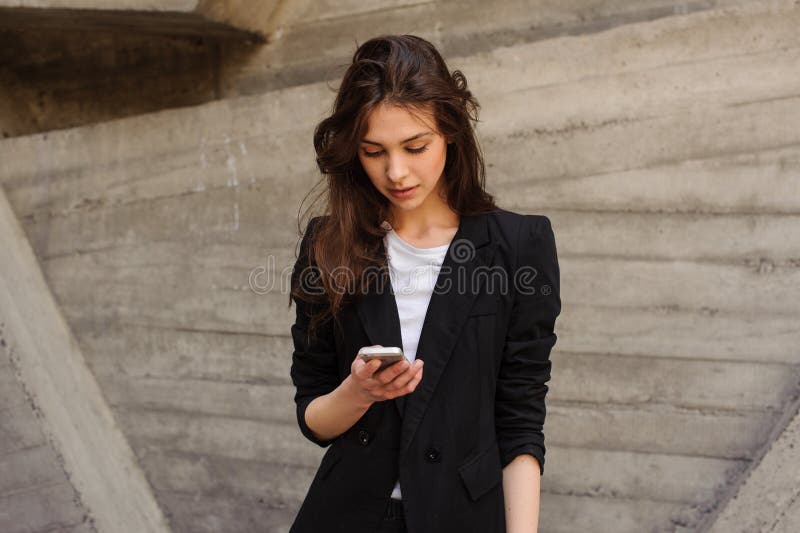 Young Caucasian Girl Text Messaging Looking at the Phone. Stock Image ...