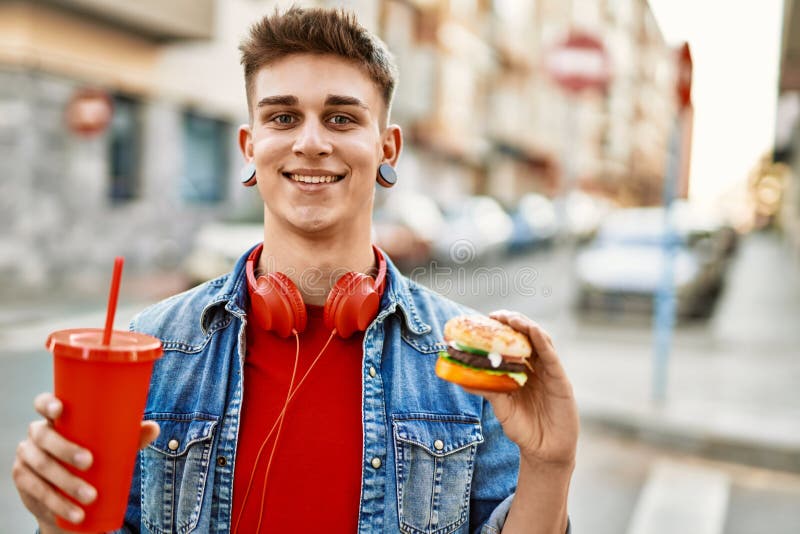 Young Caucasian Guy Eating Burger and Soda at the City Stock Image ...