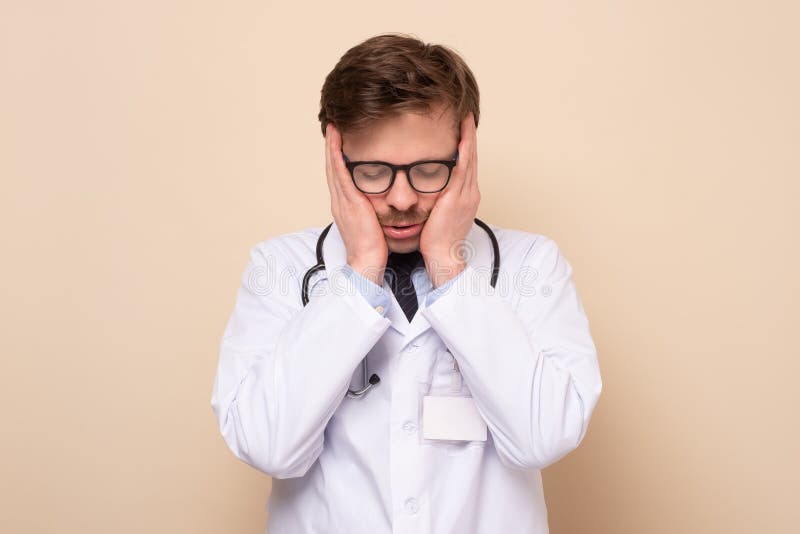 Young Caucasian Man Doctor Looking Tired after Work. Stock Image ...